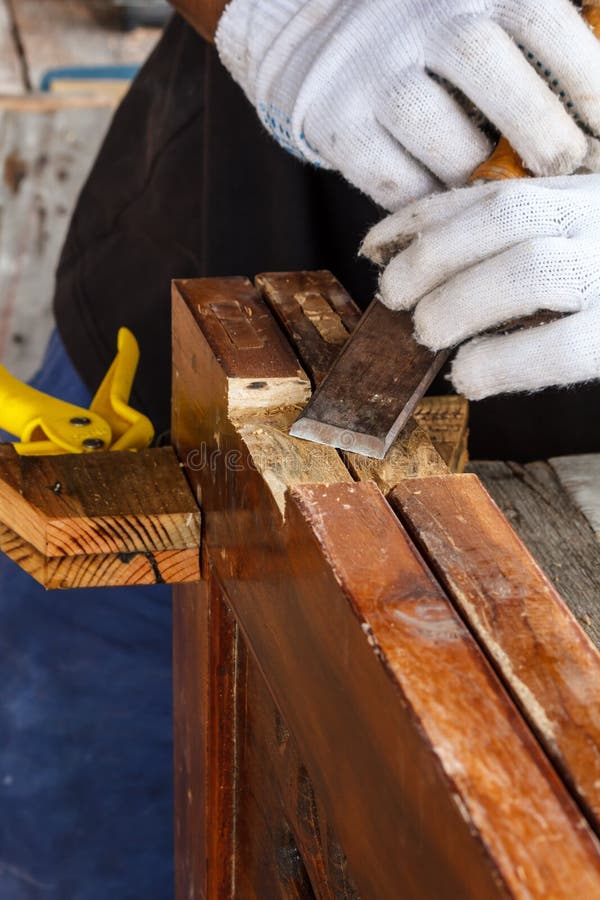 The Hand of the Carpenter Taking the Chisel To Sharpen the Wood Plank ...