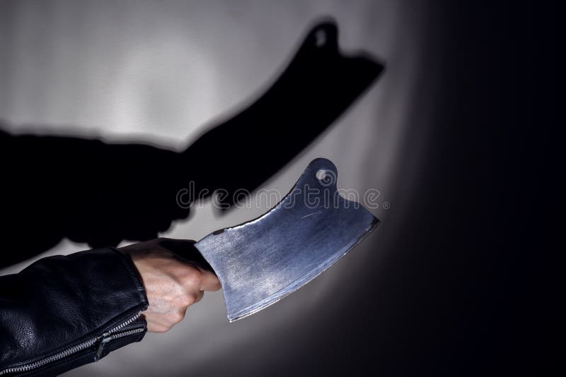 Hand with an Ax on the Background of a Wall with a Shadow from the Ax ...