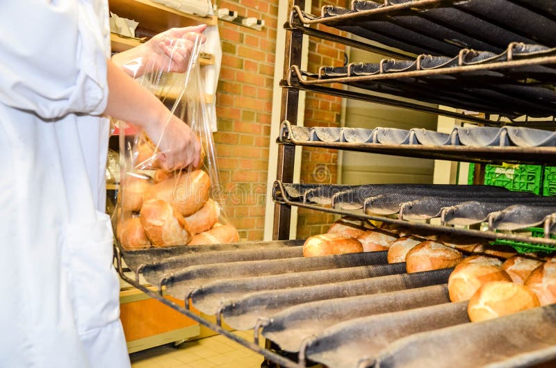 Hand of Baker or Apprentice Baker Taking Baguettes Out of Oven Stock ...