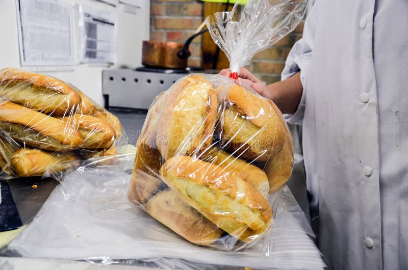 Hand of Baker or Apprentice Baker Taking Baguettes Out of Oven Stock ...