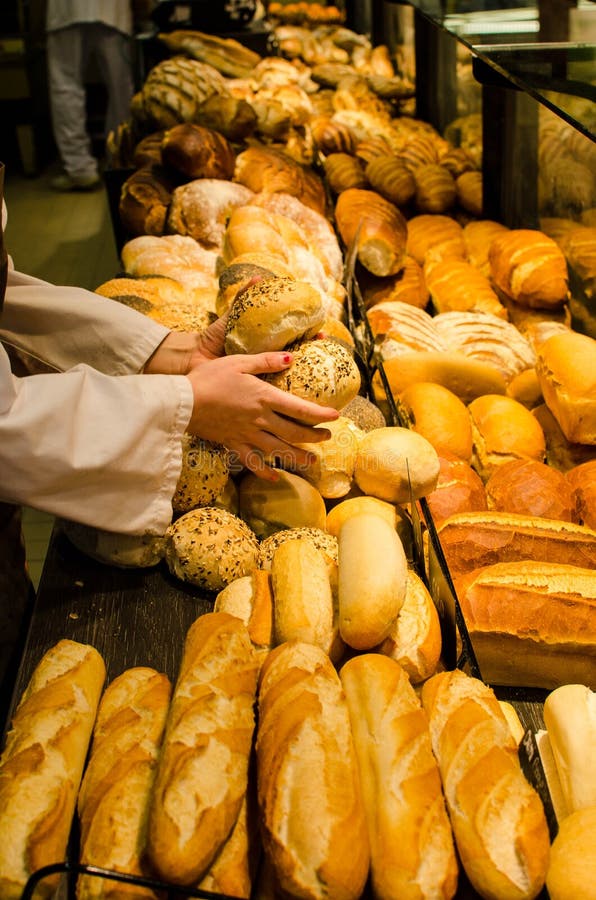 Hand of Baker or Apprentice Baker Taking Baguettes Out of Oven Stock ...