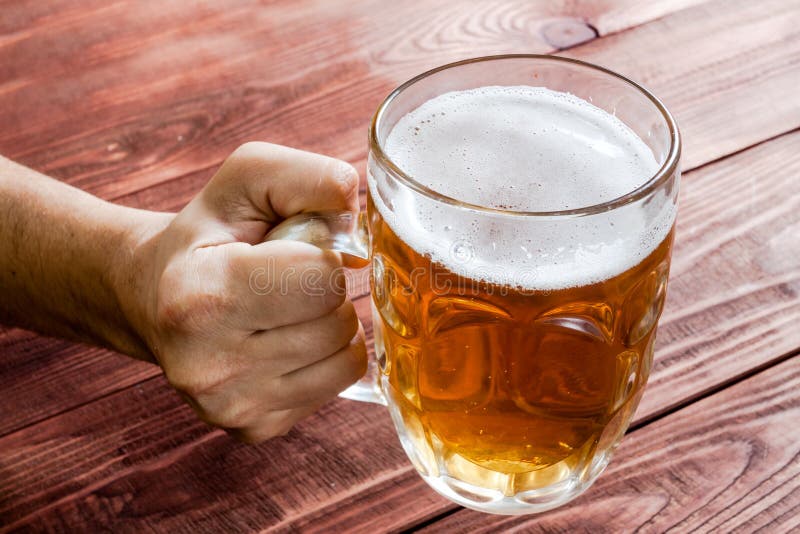 Hand with beer glass stock photo. Image of alcoholism - 55812690