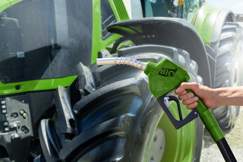 Hand with Biofuel Refueling Nozzle on a Background of Agricultural ...