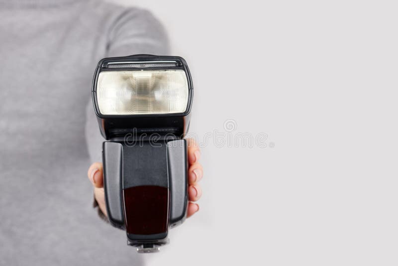 Hand with Black Camera Flash on Grey Background Stock Photo - Image of ...