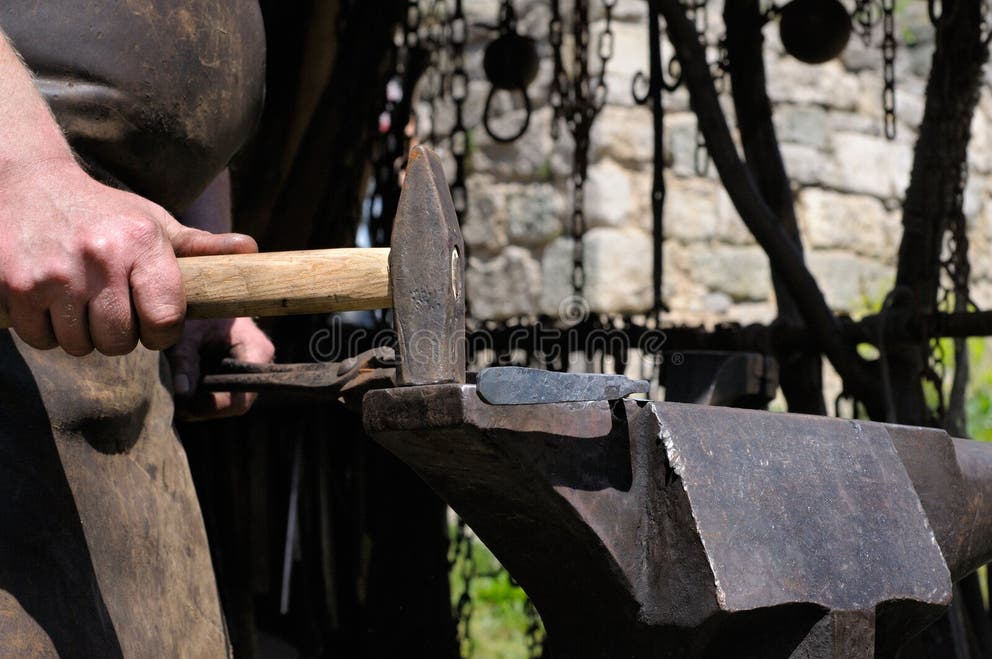 Hand of blacksmith at work stock photo. Image of industry - 20195824