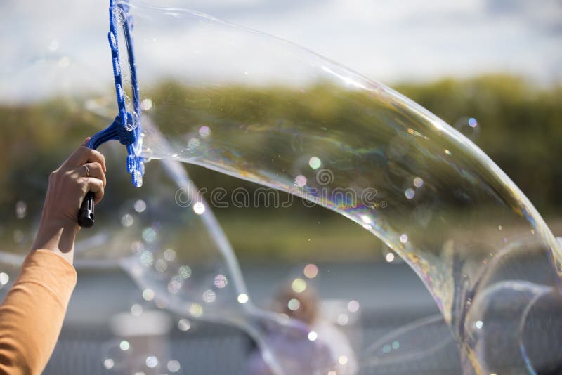 Hand blows soap bubbles stock image. Image of background - 187375145