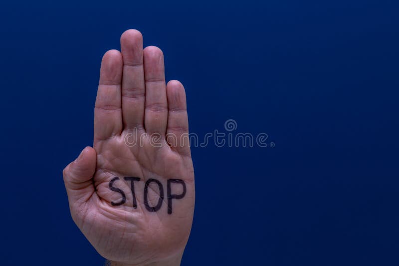 Men S Hand on a Blue Background with the Word STOP Stock Photo - Image ...