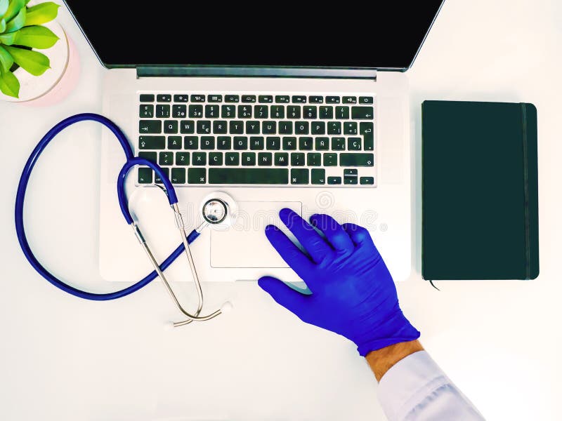 Hand with Blue Glove Using Laptop Computer. Stethoscope, Notebook and ...