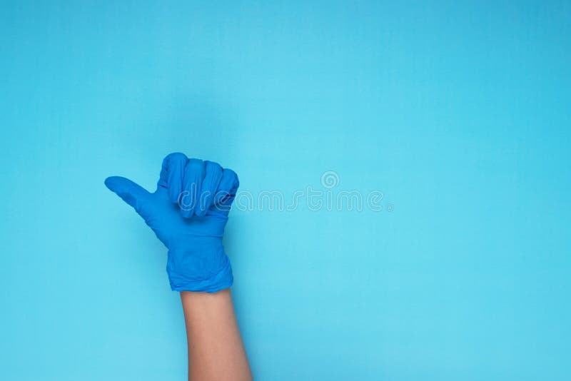 Hand in Blue Medical Glove Making Hand Gesture on Light Blue Background ...
