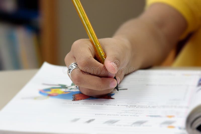 Hand of boy holding pencil stock photo. Image of concept - 8232966
