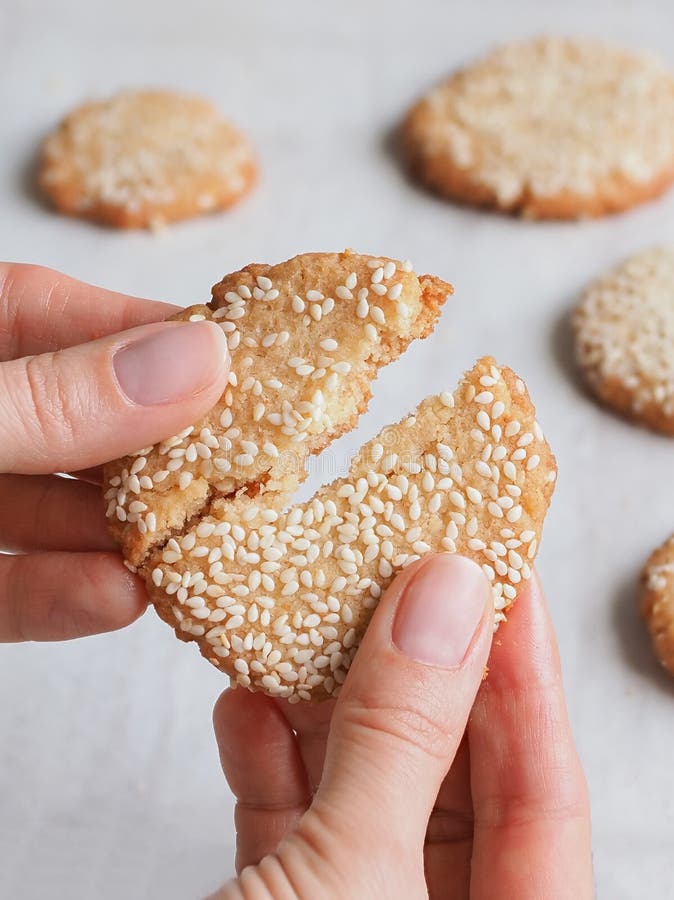 Hand Breaks Fresh Delicious Sesame Cookies. Stock Photo - Image of ...
