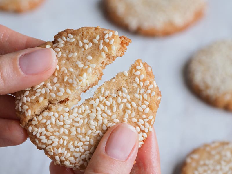 Hand Breaks Fresh Delicious Sesame Cookies. Stock Image - Image of ...