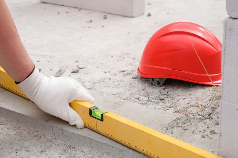 The Hand of the Builder Measures the Level of the Plane Using the ...