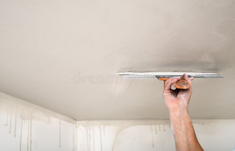 Builder with a Putty Knife, Apply the Putty To the Wall. Repair the ...