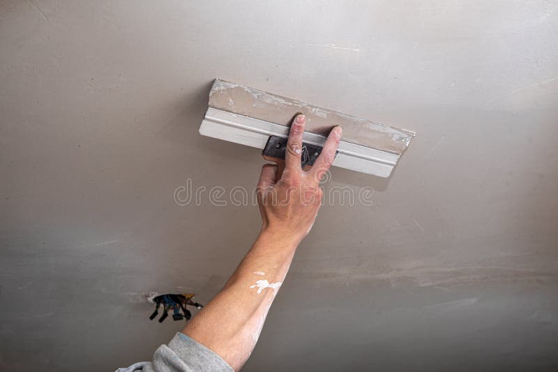 Hand of Builder Worker Spacks Ceiling with Putty Plaster Aligning ...