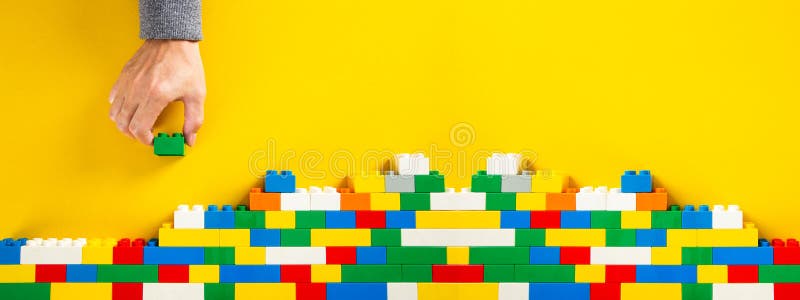 Hand Building Up a Wall by Stacking Up Plastic Block Stock Photo ...