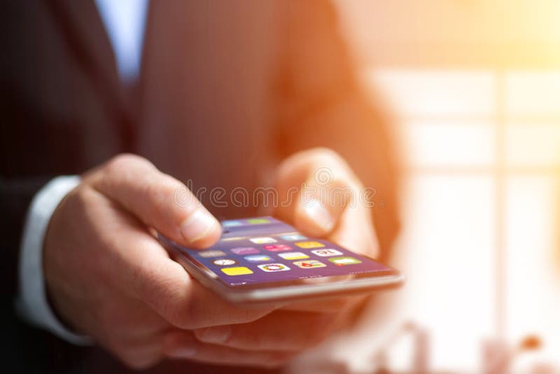 Hand of a Business Man Holding Black Smartphone with Operating S Stock ...