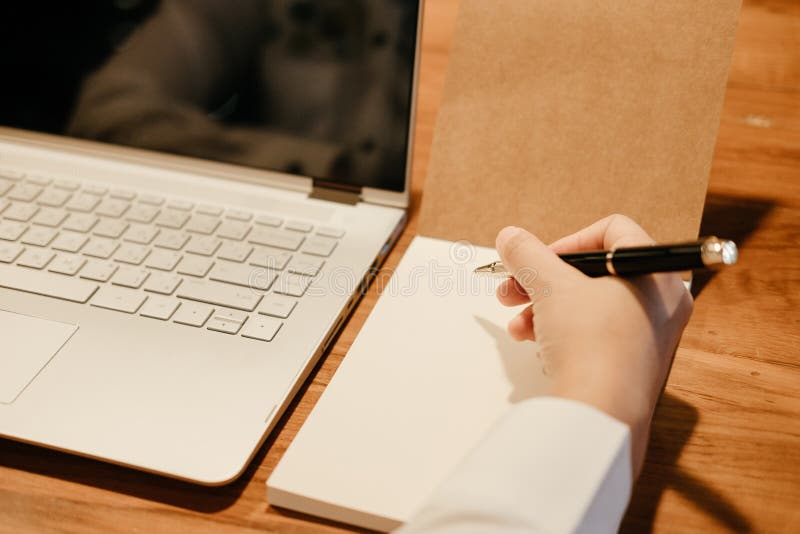 Hand of Businessman Hold Pen Write on Notebook. Computer Notebook ...