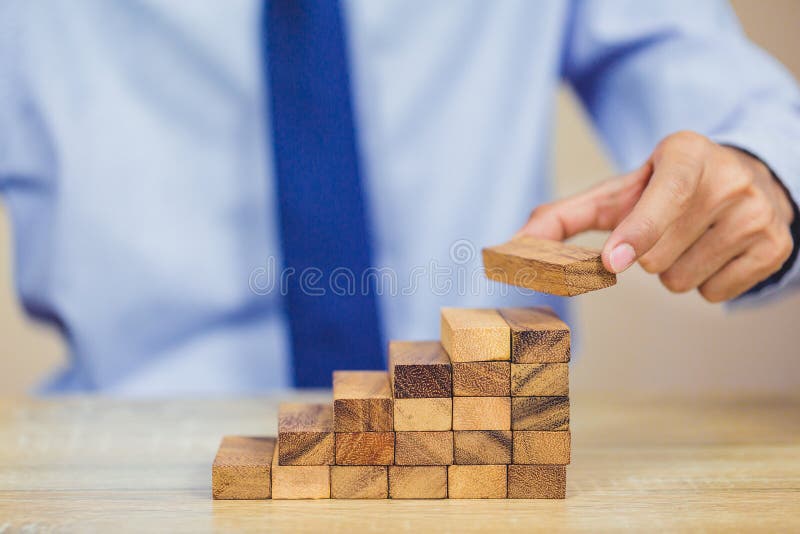 Hand of Businessman Pulling Out or Placing Wood Block Stock Image ...
