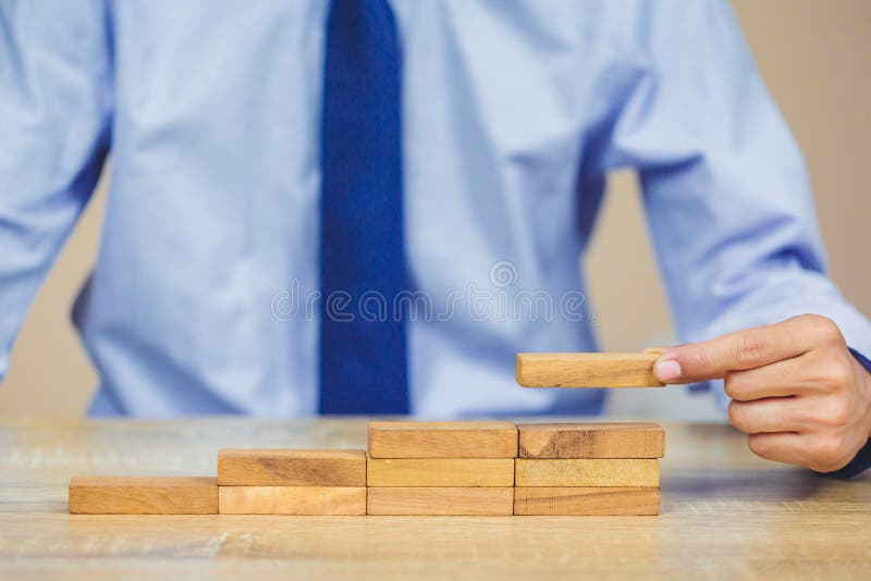 Hand of Businessman Pulling Out or Placing Wood Block Stock Image ...