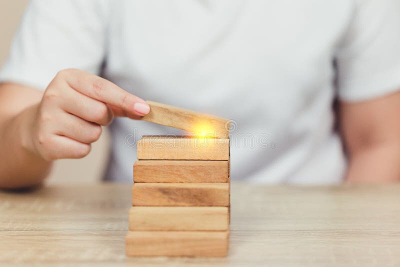 Hand of Businessman Pulling Out or Placing Wood Block Stock Image ...