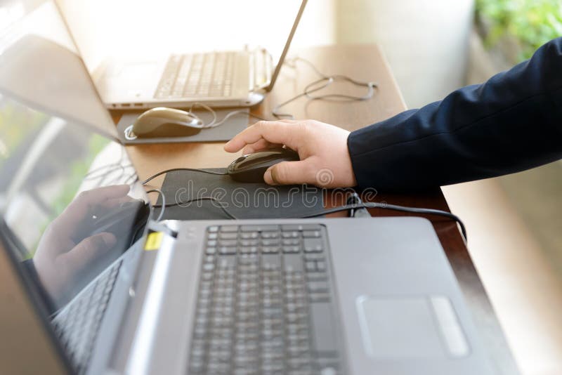 Hand of Businessman Touching a Computer Mouse with Laptop Computer ...