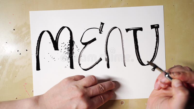 Hand Calligraphy Creation of Bold Menu Sign on White Paper with Brush ...