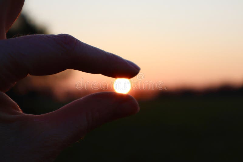Hand Capturing the Sun stock photo. Image of sunset - 125897814