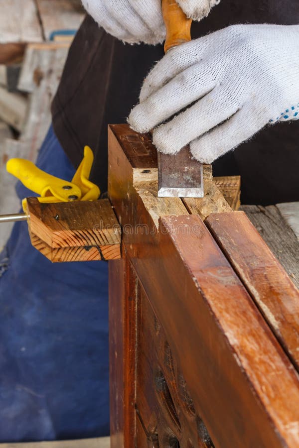 The Hand of the Carpenter Taking the Chisel To Sharpen the Wood Plank ...