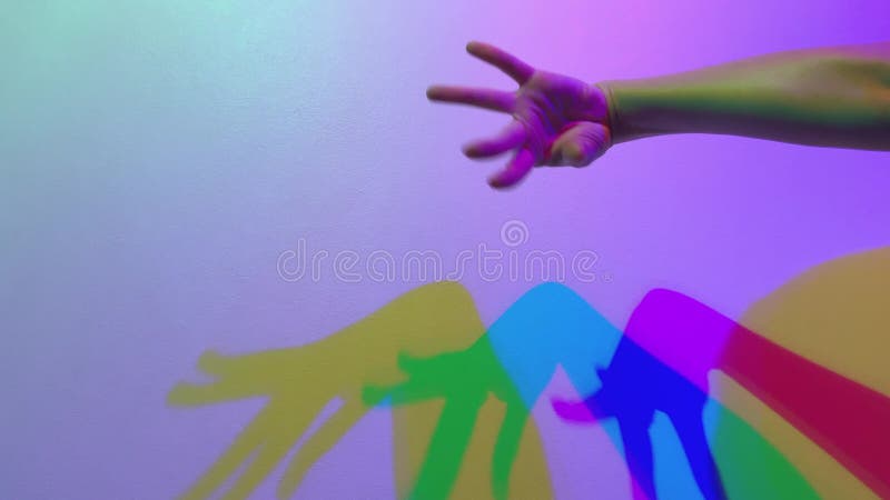 Hand Casting Colorful Shadows on a Wall with a Vibrant Light Effect ...