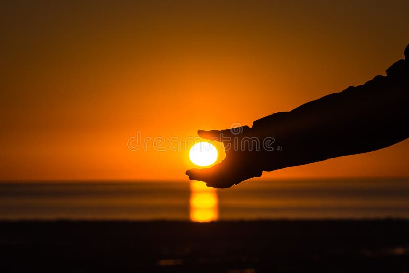 Hand Catching the Sun during the Sunset. Stock Photo - Image of light ...