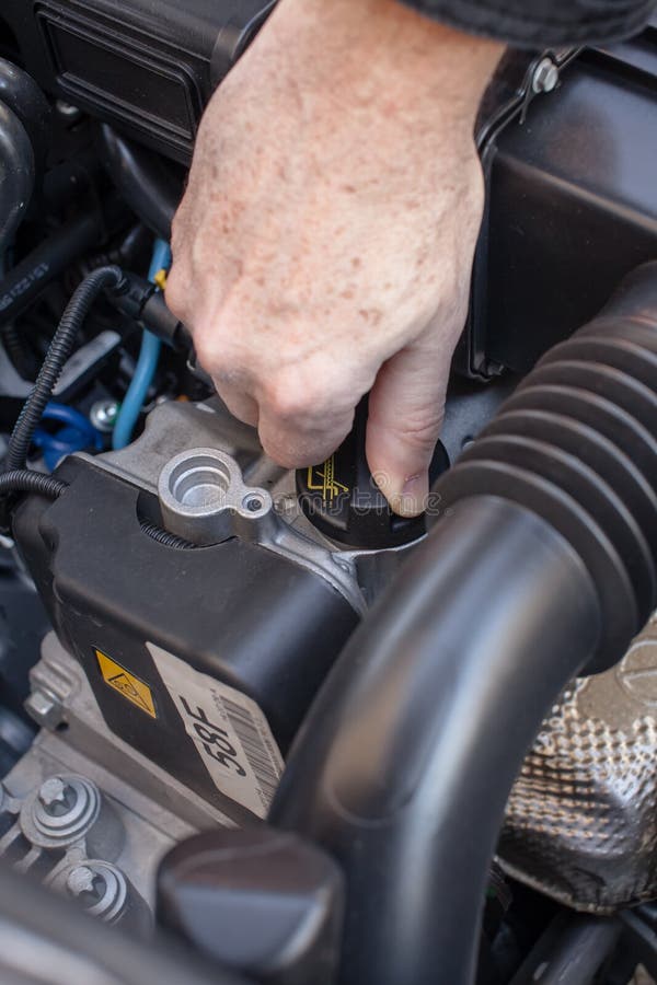 Hand Checking the Oil Cap of a Car Engine Stock Photo - Image of ...