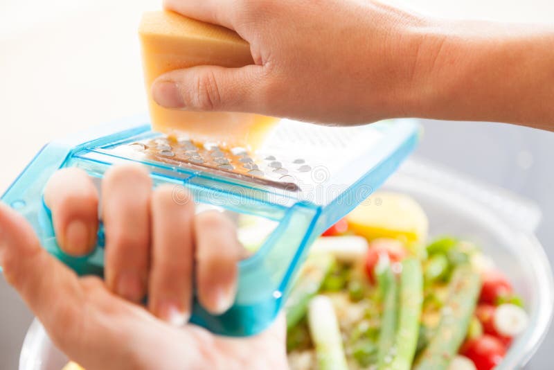 Hand on a cheese grater stock photo. Image of board, snack - 78443988