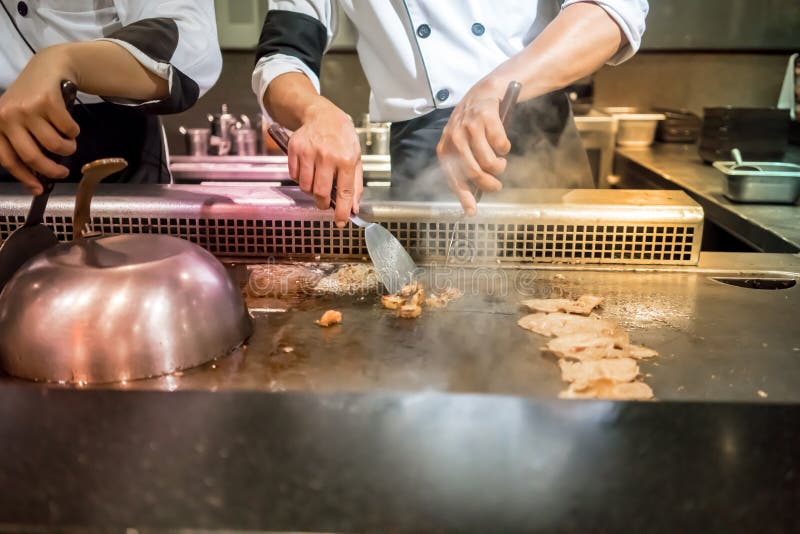 Hand of Chef Cooking Beef Steak on Hot Pan in Front of Customers Stock ...