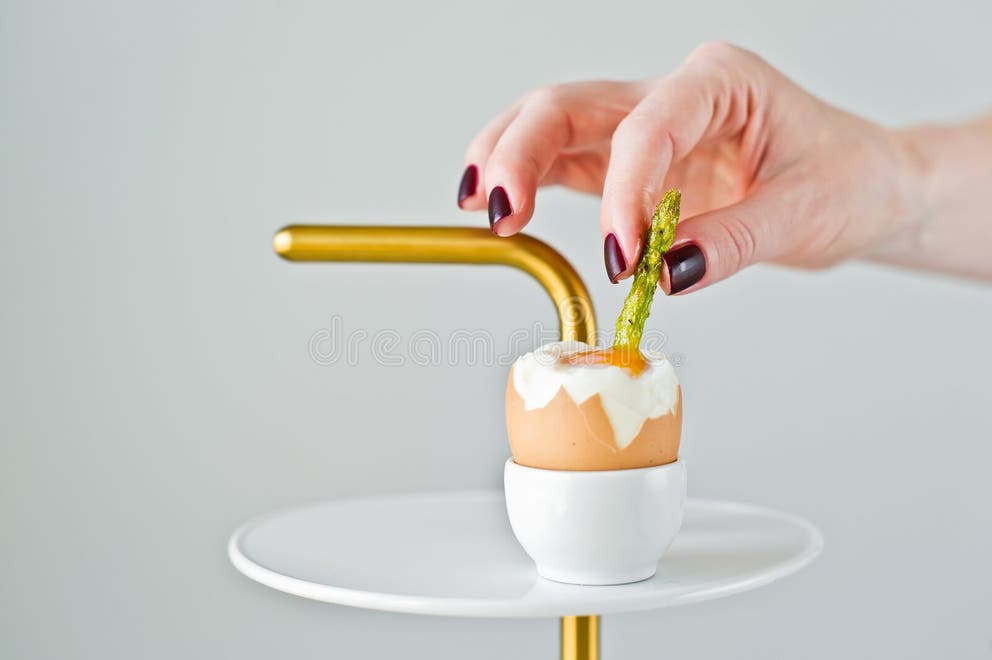 Hand Chef Inserts a Trickle of Asparagus in a Boiled Egg Stock Photo ...