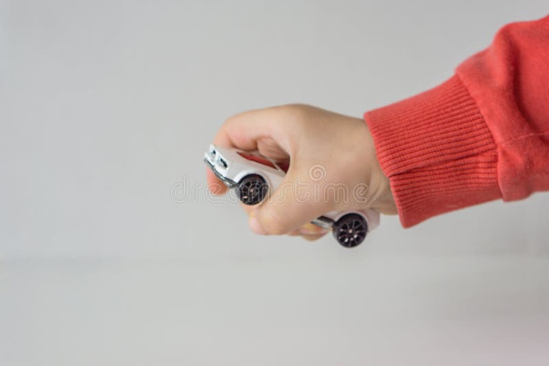 Hand of a Child Holding a Small White Car. Stock Image - Image of color ...