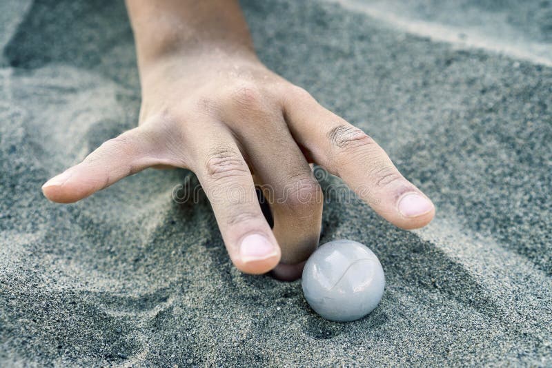 Young girl playing marbles stock photo. Image of finger - 9023566