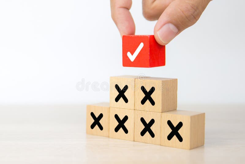 Hand Choose Check Mark on Cube Wooden Toy Block Stack with Cross Symbol ...