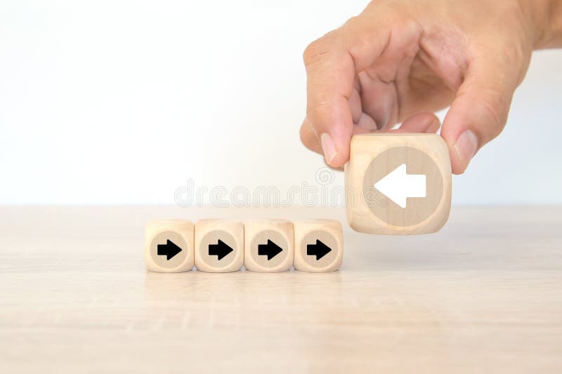 Hand Chooses Arrow Icon Point To the Opposite Side on Cube Wooden Block ...