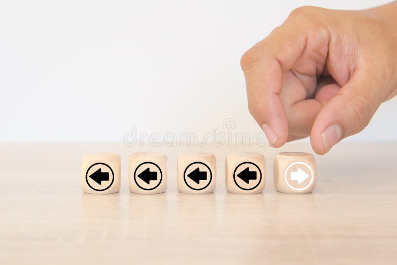 Hand Chooses Arrow Icon Point To the Opposite Side on Cube Wooden Block ...