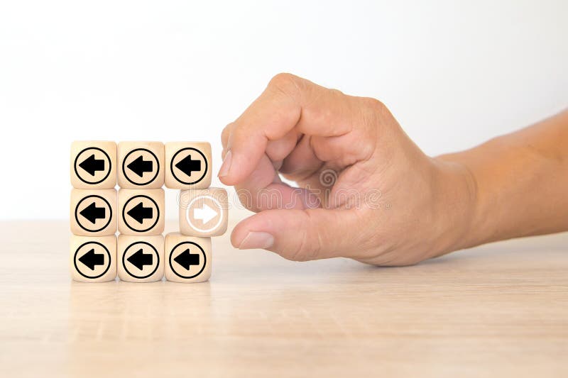 Hand Chooses Arrow Icon Point To the Opposite Side on Cube Wooden Block ...