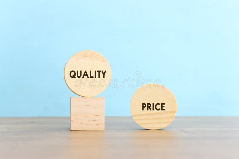 A Hand Chooses a Cube with the Word Quality, Versus Price Stock Photo ...