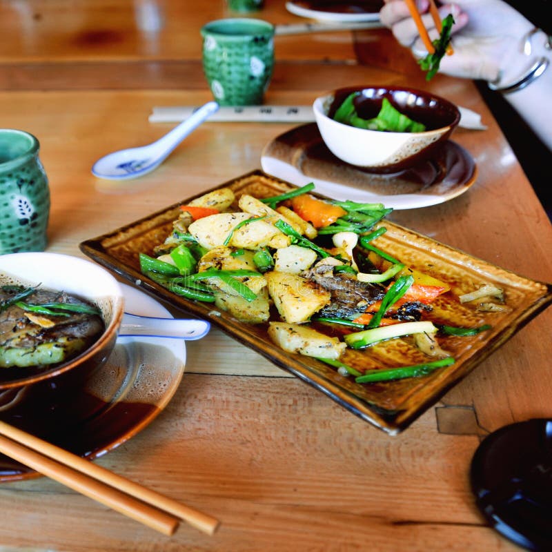 Hand with Chopsticks and Dinner Table Stock Photo - Image of setting ...