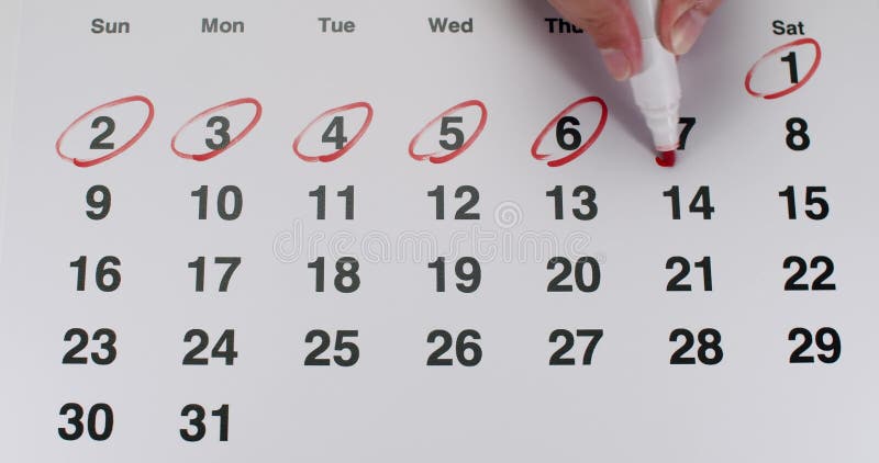 Hand Circling Dates on Calendar with Red Marker for Planning and ...