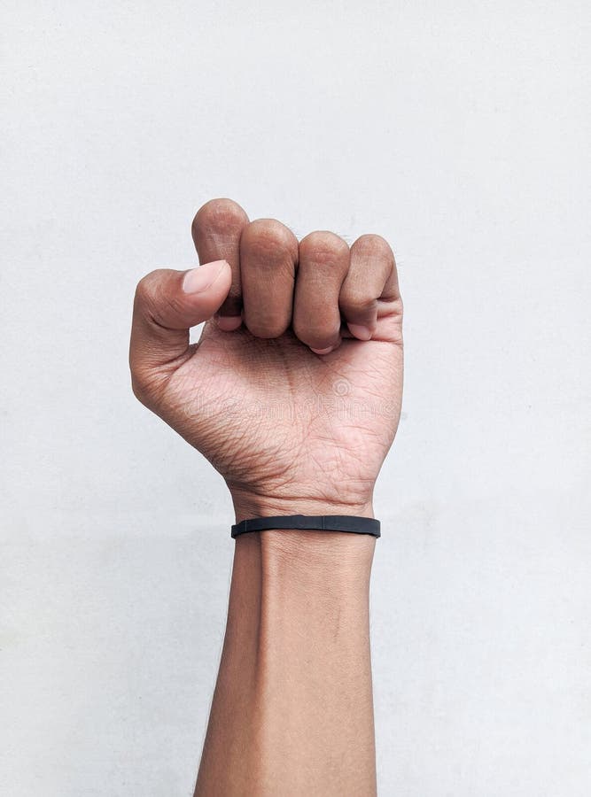 Hand Clasping with Black Rubber Band on Wrist White Background. Close ...