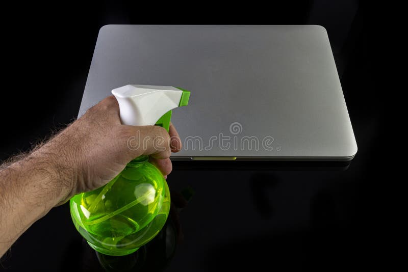 Hand Cleaning a Laptop with a Spray Bottle Sanitizer Stock Photo ...