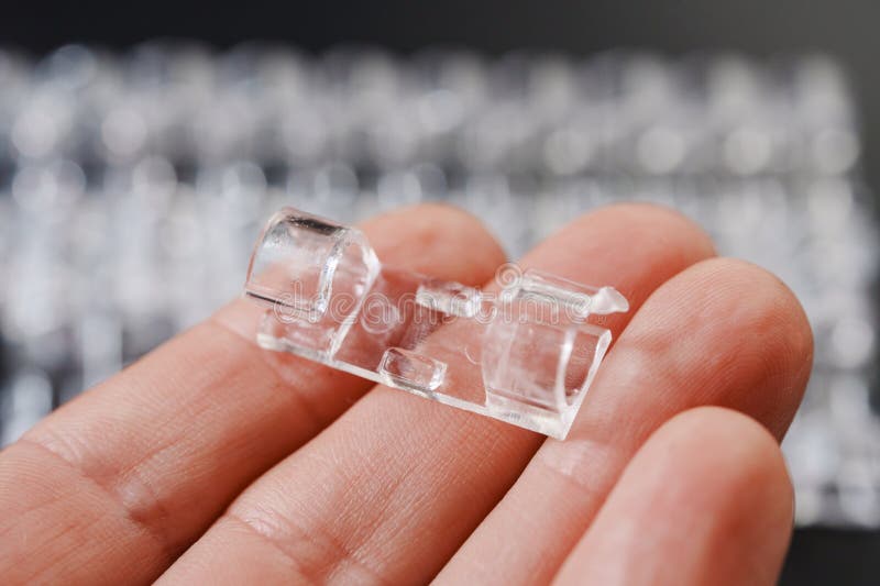 Hand and Clear Plastic Wire Holders on the Black Surface. Stock Image ...