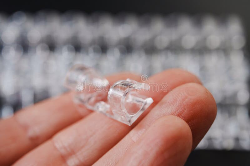 Hand and Clear Plastic Wire Holders on the Black Surface. Stock Photo ...