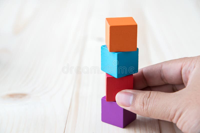 Hand on Colorful Stack of Wood Cube Building Blocks Stock Image - Image ...