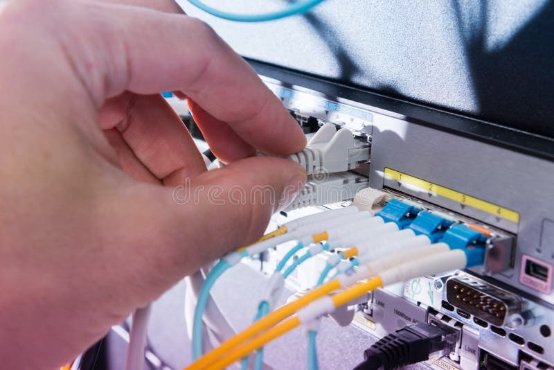 Hand of Computer Engineer Connecting Fiber Optic Cable in Server Stock ...